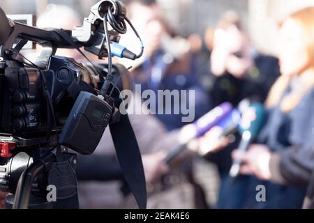Filming an event with a video camera. Spokesperson Stock Photo - Alamy