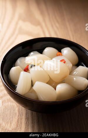 Japanese Rakkyo placed on a wooden background Stock Photo - Alamy