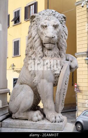 Stone lion holding shield outside of the of Basilica of Santa Croce ...