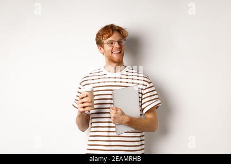 Handsome redhead male employee in glasses having break, drinking coffee ...