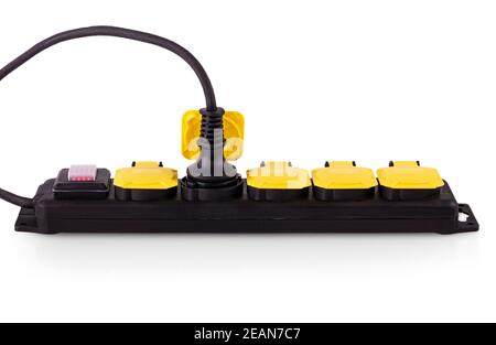 The Plugged electric devices in an extension yellow cord isolated Stock ...