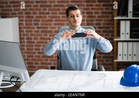 Scanning Blueprint Plan Document Using Phone. Taking Photo Stock Photo ...