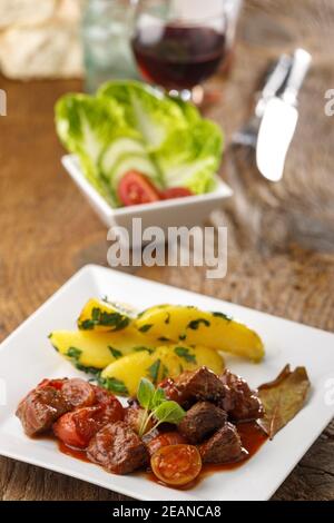Greek stifado meat stew with potatoes Stock Photo - Alamy