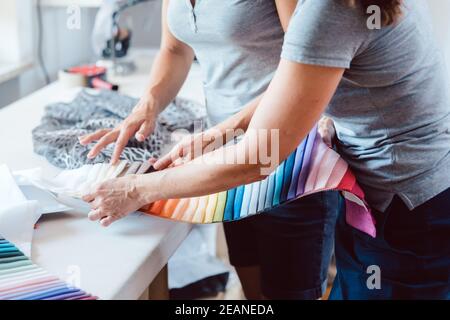 Hands on fabric pattern palette on studio table Stock Photo - Alamy