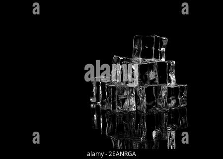 Ice cubes are arranged in a slide, isolated on a black background Stock ...