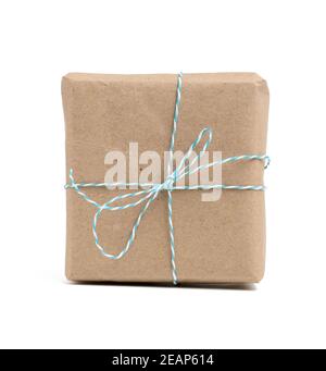box wrapped in brown kraft paper and tied with a pink ribbon, gift ...