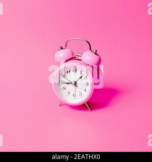 Pink alarm clock Stock Photo - Alamy