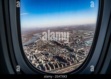 Beijing skyline visible from the window of an airplane. Shooting ...