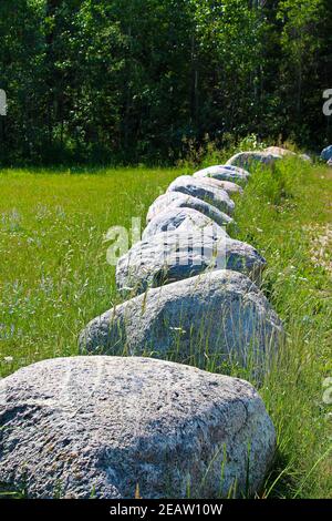 Boulders places on the edge of parking lot for a border Stock Photo - Alamy