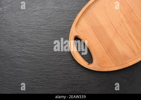 empty oval brown wooden tray board on a wooden background, top view ...