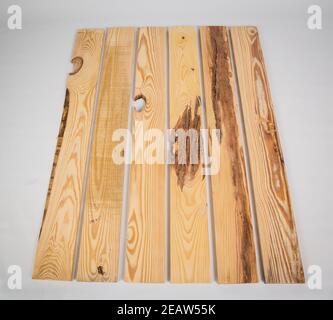 Unfinished raw pine lumber with light and dark color variation on a ...