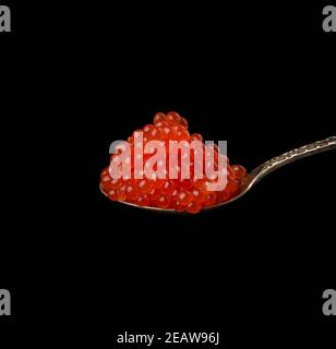 grainy red caviar in a metal spoon on a wooden board Stock Photo - Alamy