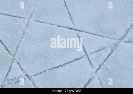 ice covered with snow lined skate tracks abstract white background ...