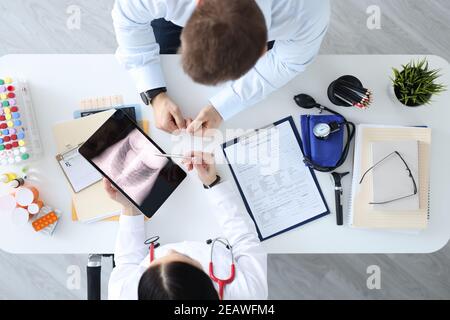 Top view of Doctor showing a x-ray of pain in the neck. Migraine ...