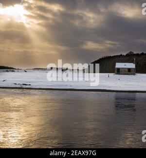 The Sands Shiel on the River Tweed sets over a snow covered landscape ...