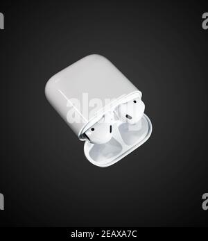 White earbuds in case on wooden surface. Minimalist design, clean ...