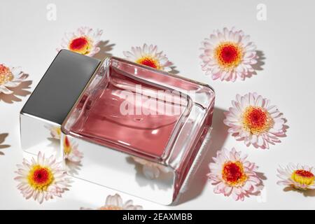 Bottle of fragrance surrounded by flower buds Stock Photo - Alamy