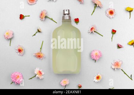 Bottle of fragrance surrounded by flower buds Stock Photo - Alamy