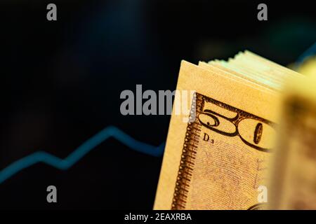 American dollar banknotes and graph on black background Stock Photo - Alamy