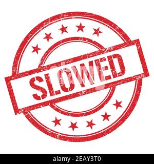 SLOWED text written on red grungy vintage round stamp Stock Photo - Alamy