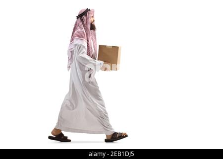 Saudi arab man walking with a cardboard box isolated on white ...