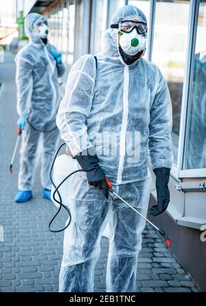 Covid specialist wearing decontamination protective suit and ...