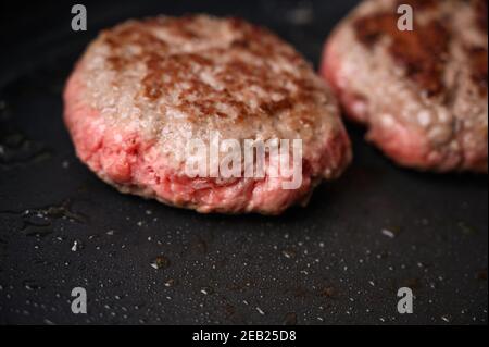 Closeup shot of a homemade hamburger cutlet frying in a pan Stock Photo ...