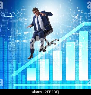 Businessman sliding down on chair in economic crisis concept Stock ...