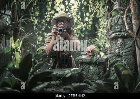 Brave woman exploring the jungle and taking pictures with her camera ...