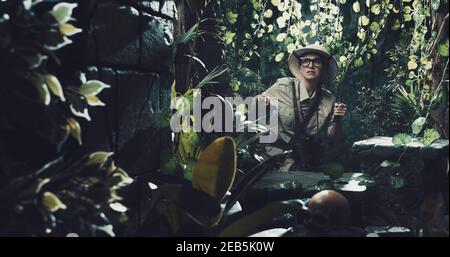 Scared explorer walking in the jungle and finding a human skull, she is ...