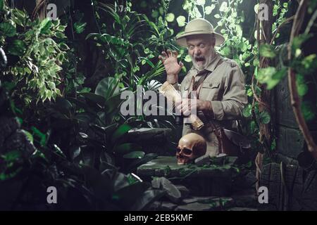 Scared explorer walking in the jungle and finding a human skull, she is ...