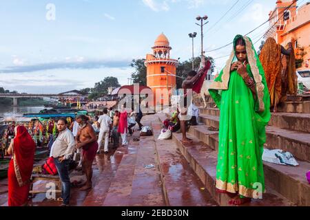 Chitrakoot, Madhya Pradesh, India : A woman in a colourful sari squats ...