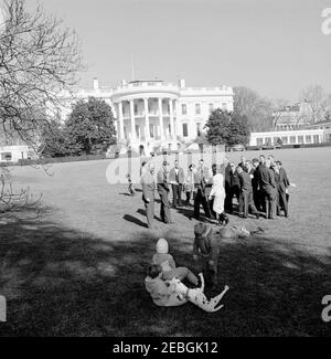 John F. Kennedy, Jr., plays with his dog, Shannon, at Brambletyde house ...