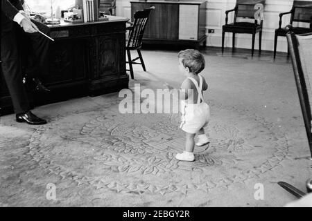 John F. Kennedy, Jr., plays with his dog, Shannon, at Brambletyde house ...