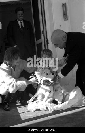 John F. Kennedy, Jr., plays with his dog, Shannon, at Brambletyde house ...