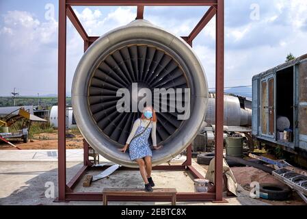 Girl sat inside a jet turbine engine providing human size comparison ...