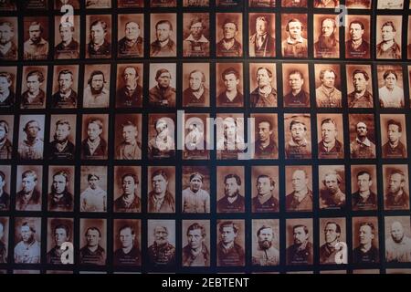 Wall of prisoner portraits with their crime noted on their photo at ...