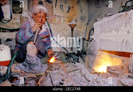 A traditional Arabic blacksmith working in Katara cultural village ...