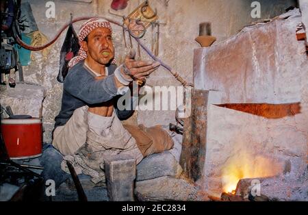 A traditional Arabic blacksmith working in Katara cultural village ...