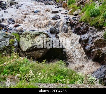 A powerful stream of water is squeezed between the sides of the rocks ...