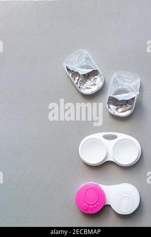 Accessories for contact lenses: a solution container, tweezers. Yellow ...
