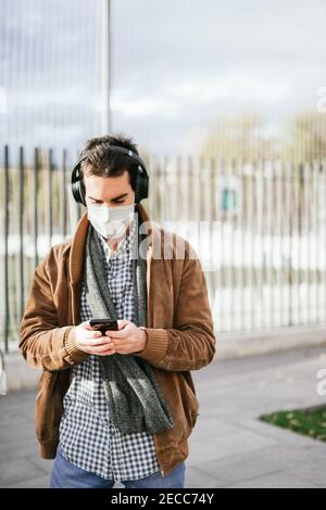 Young handsome man holding covid record card smiling happy and positive ...