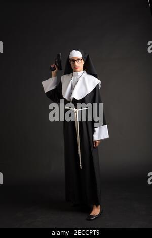 Portrait of a disguised nun on black background Stock Photo - Alamy