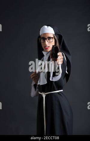 Portrait of a disguised nun on black background Stock Photo - Alamy