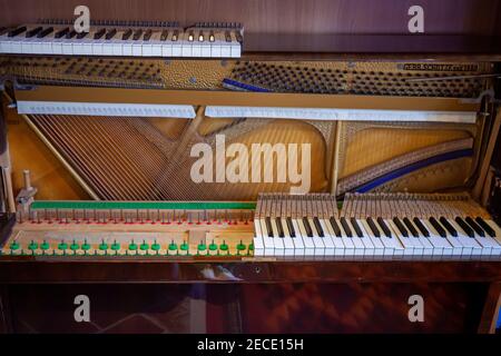 Disassembled upright piano for repair, service, tuning, cleaning. Open ...