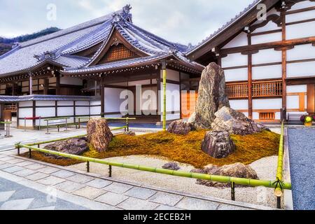 Entrance to traditional Japanese garden with stone path and tile roofed ...