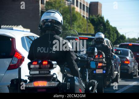 Two California Highway Patrol officers try to dodge rocks being thrown ...