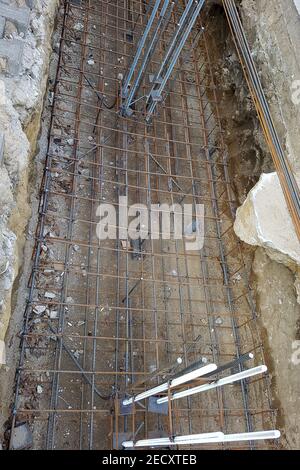 The foundation slab is made of reinforcement rods, bound with tie wire ...