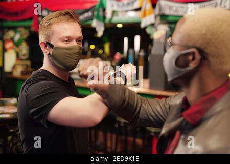 Two guys in casualwear looking at one another while trying to guess ...