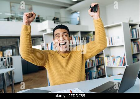 Well done, very good. Excited handsome guy praising nice work, showing ...